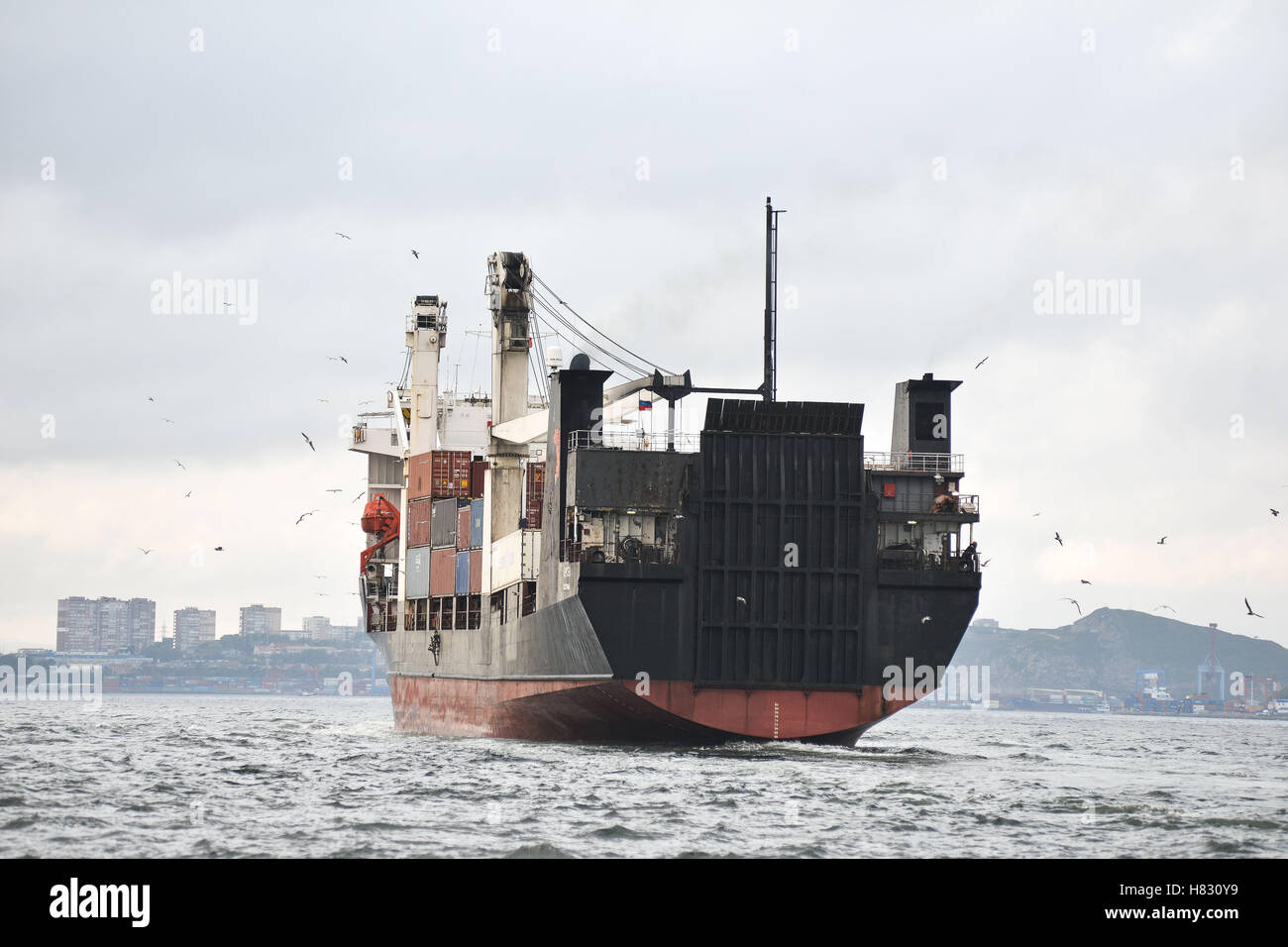 Cargo ship in harbor logos and brandnames systematically removed Stock ...