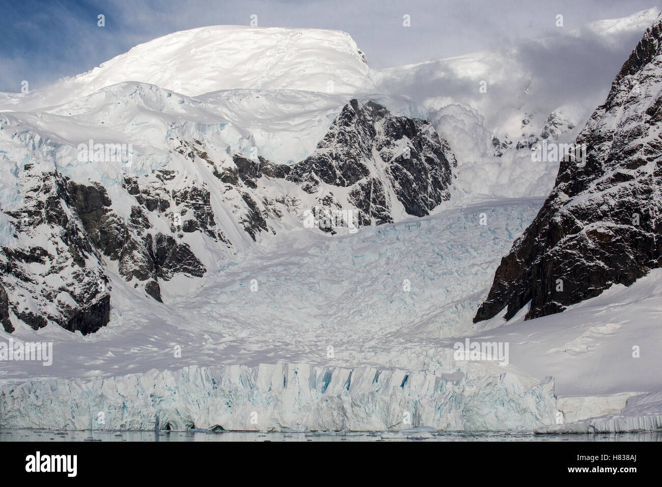 Avalanche rolling down mountain, Paradise Bay, Antarctic Peninsula ...