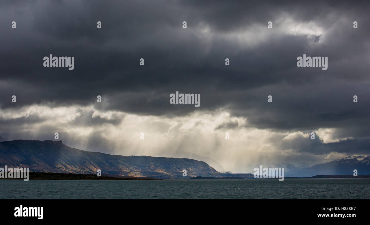 Rain clouds over coastal mountains, Puerto Natales, Chile Stock Photo ...