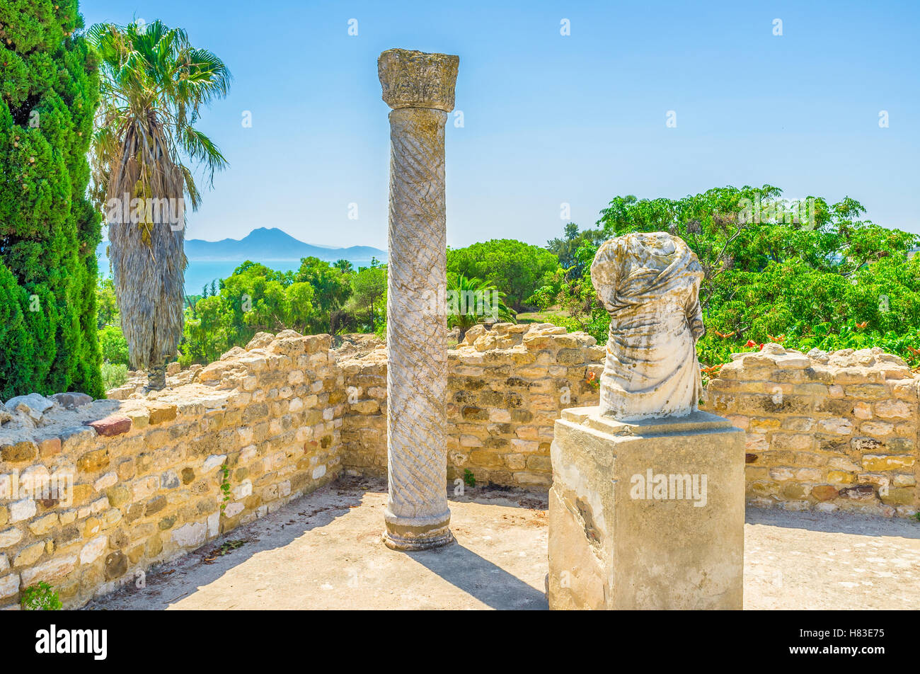 The ruins of antique Carthage surrounded by lush coastal gardens ...