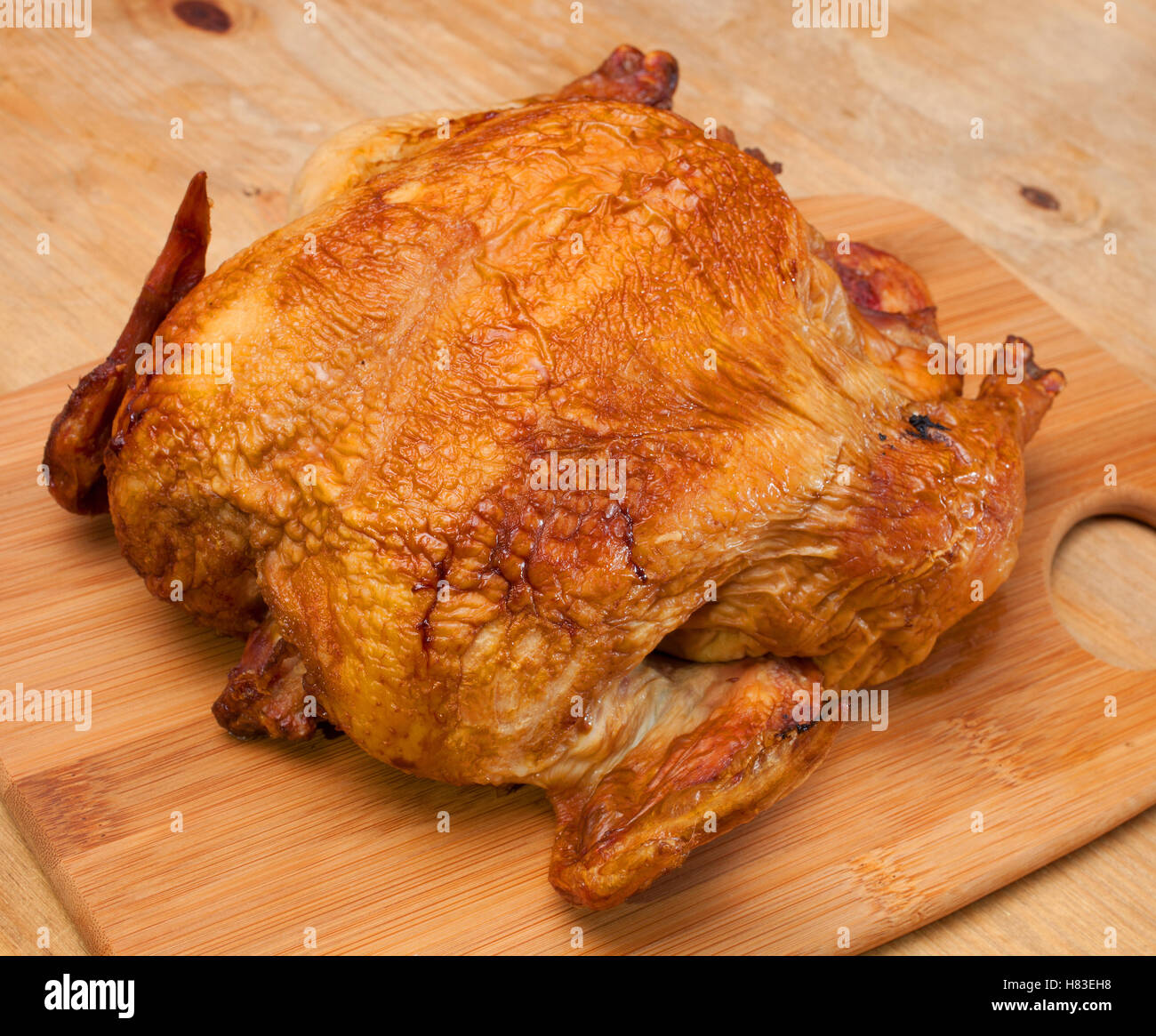 Full chicken hen that has been slowly smoked Stock Photo - Alamy