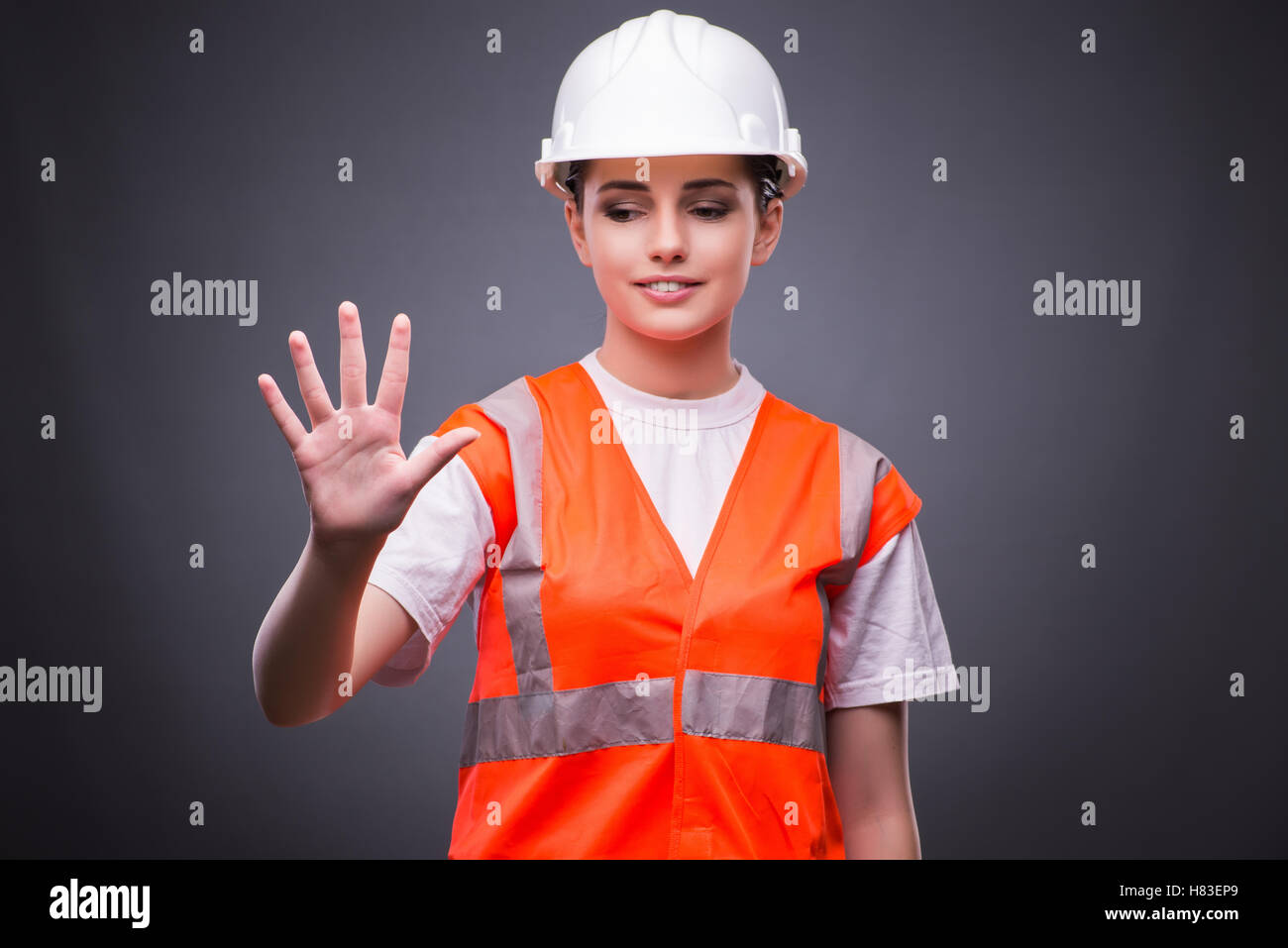 Cute construction worker pressing virtual buttons Stock Photo - Alamy