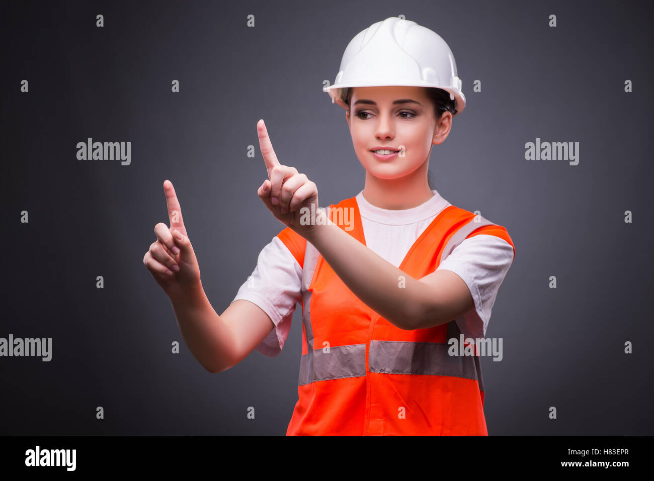 Cute construction worker pressing virtual buttons Stock Photo - Alamy