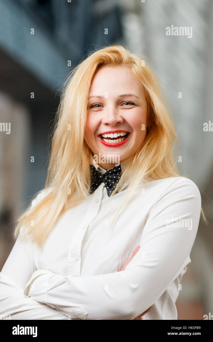 Happy ginger with red lips laughing in lobby of building Stock Photo ...