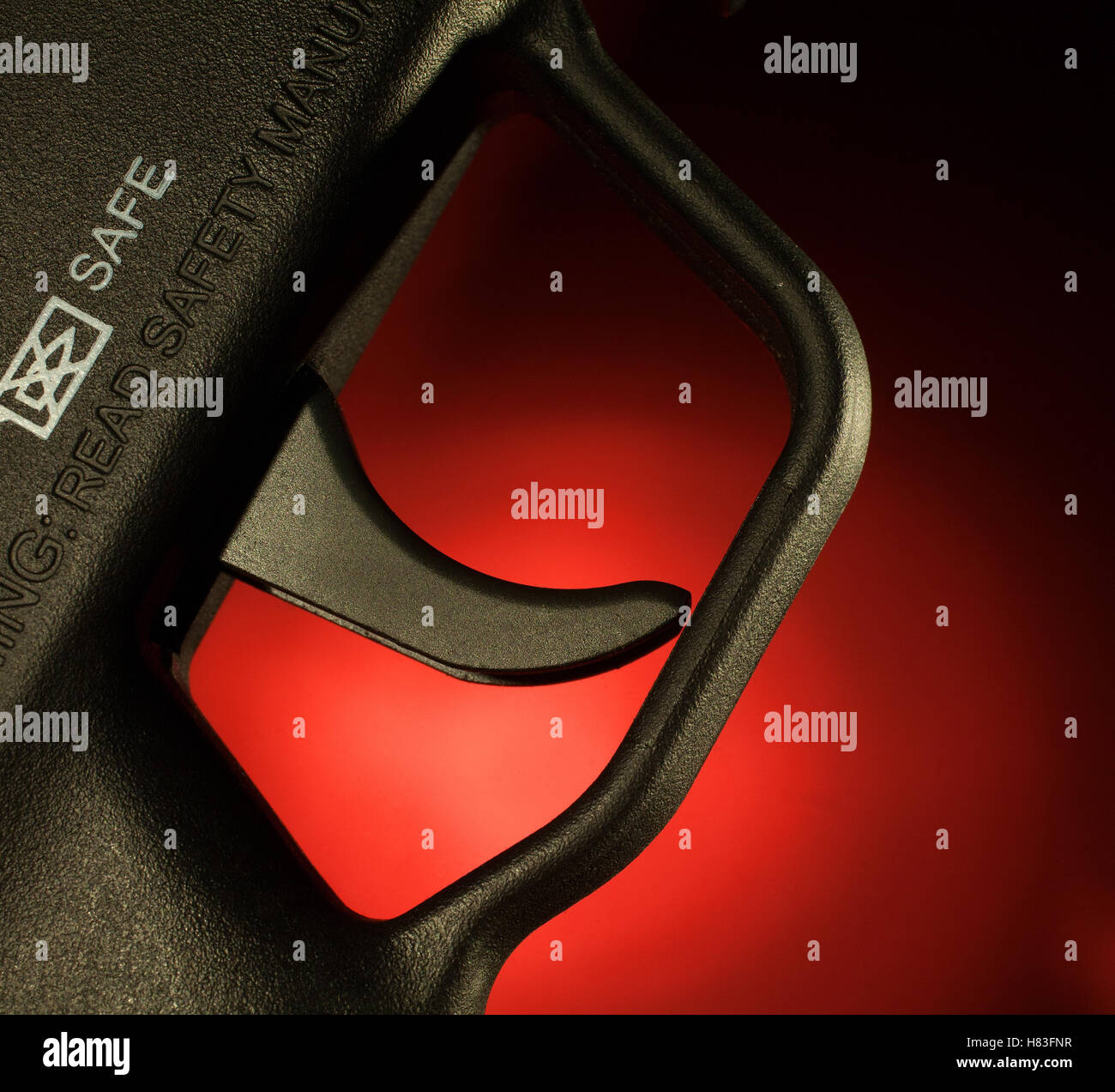 Assault rifle trigger that is with a red background Stock Photo - Alamy