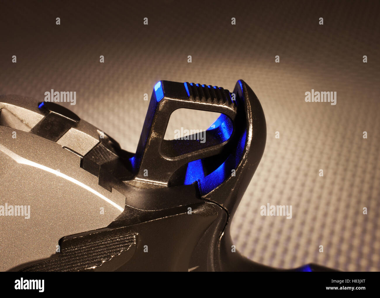 Hammer on a semi automatic handgun that is cocked with blue highlights ...