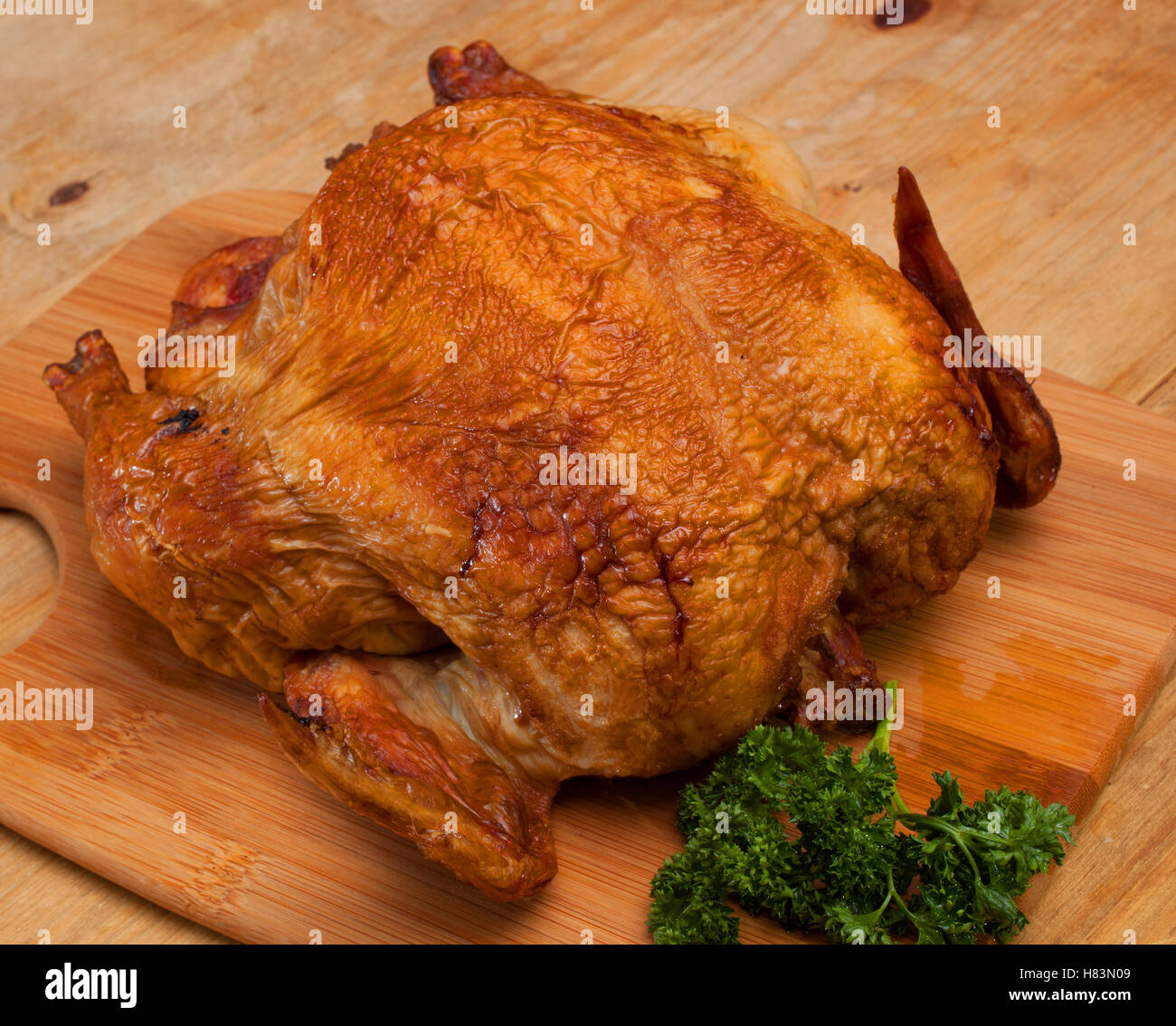 Full chicken that has been smoked slowly over a fire Stock Photo - Alamy