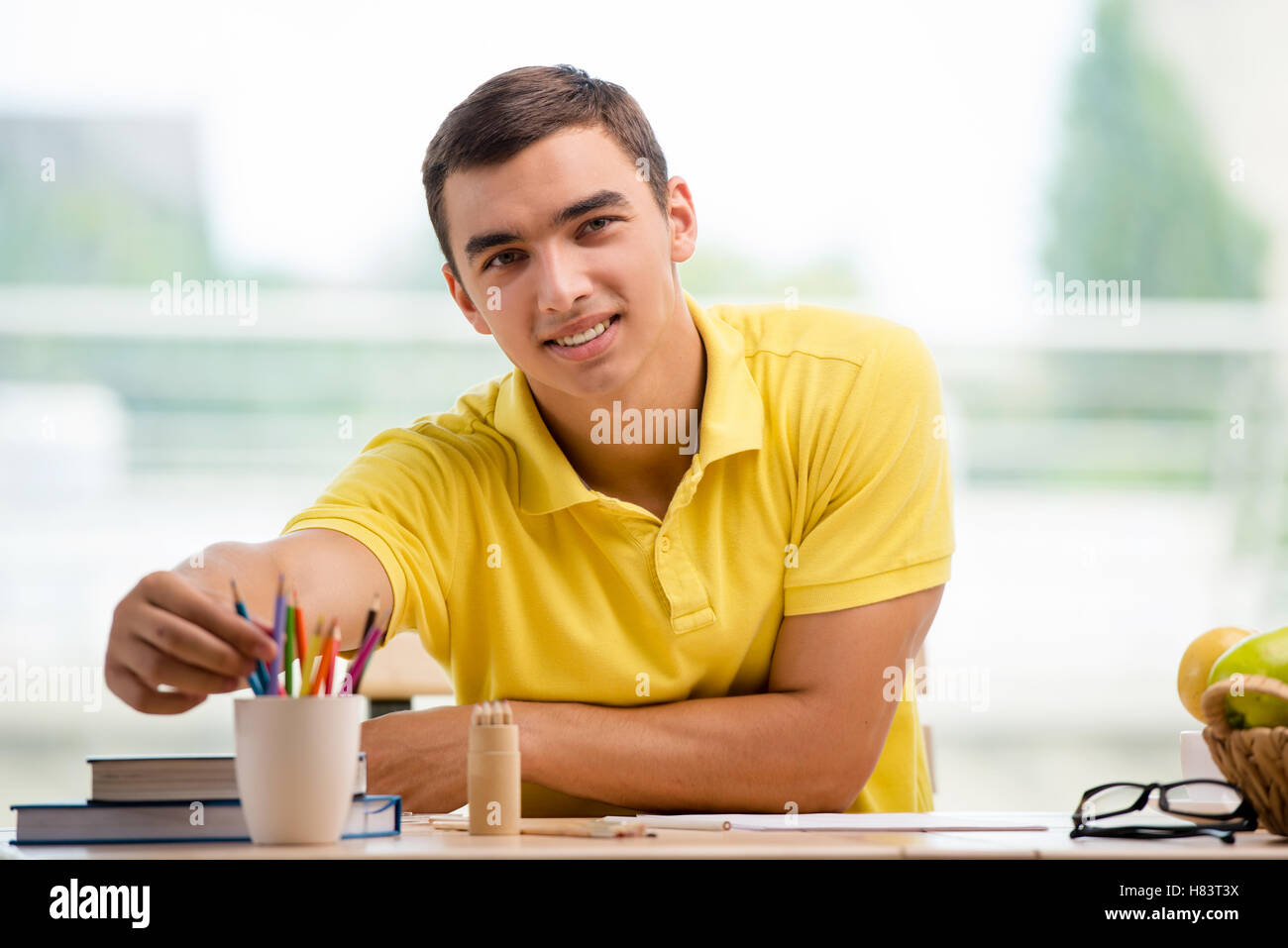 Young man drawing pictures in studio Stock Photo - Alamy