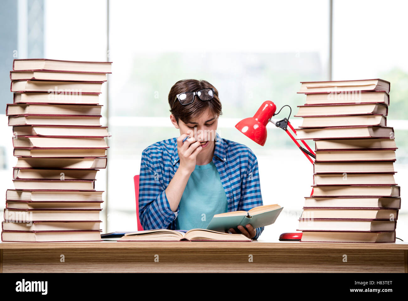 Student with lots of books preparing for exams Stock Photo - Alamy