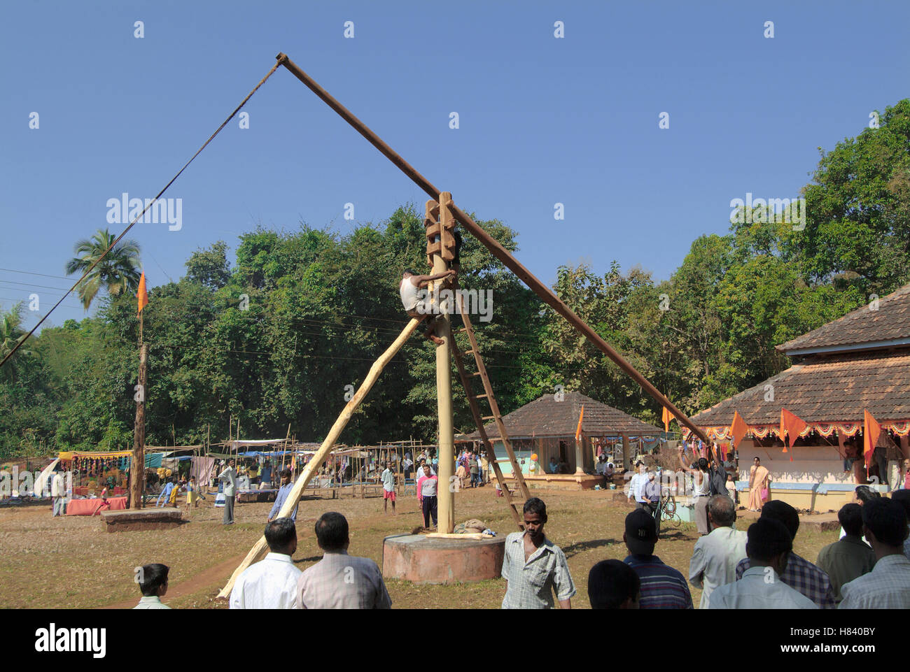 Religious tradition called ‘Bagada’. Devotees get hooked and hung Stock ...