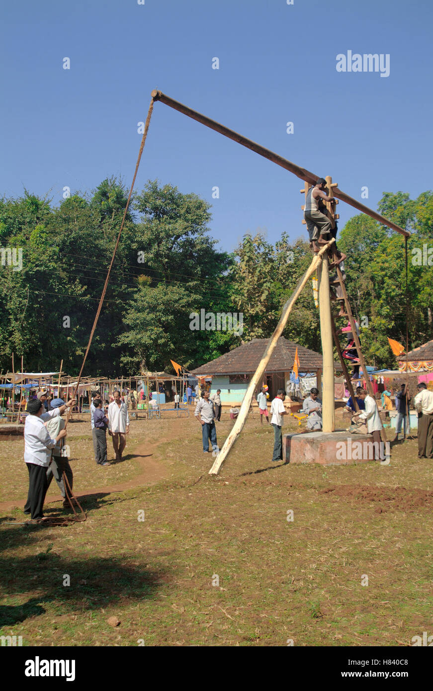 Religious tradition called ‘Bagada’. Devotees get hooked and hung Stock ...