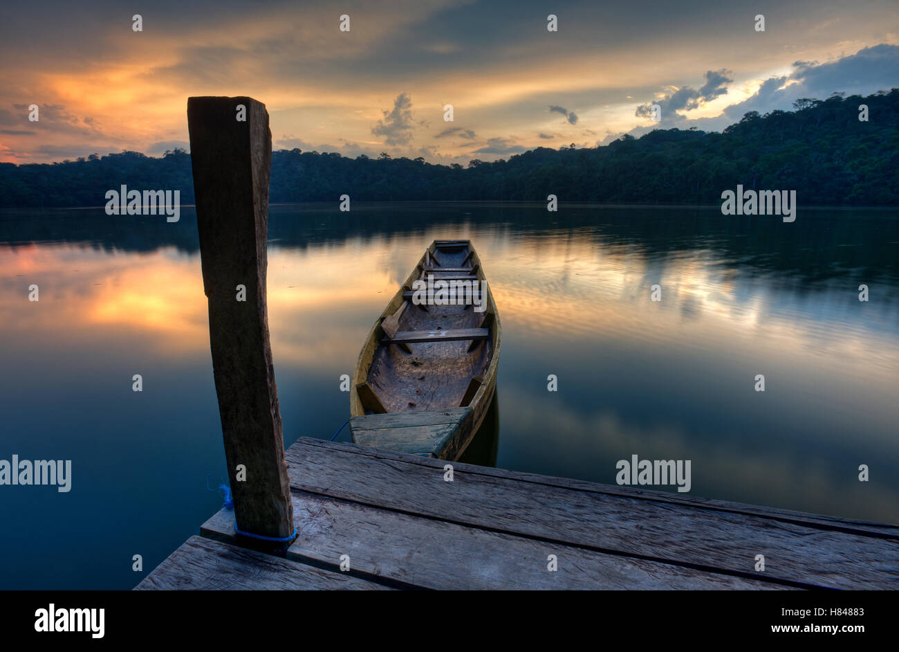 A small dock and canoe, Lake Chalalan, Madidi National Park, Bolivia ...