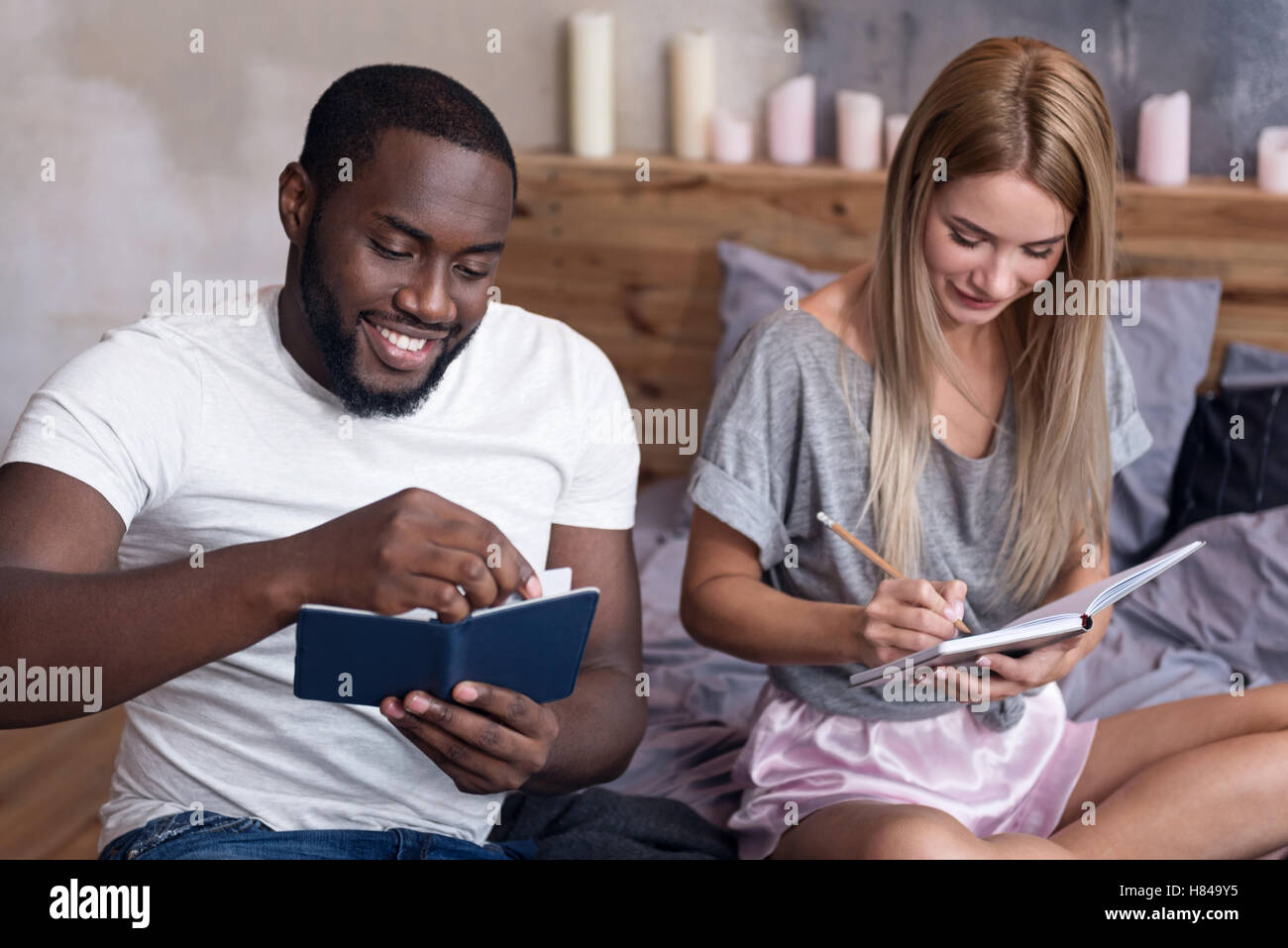 Happy couple making notes together Stock Photo - Alamy