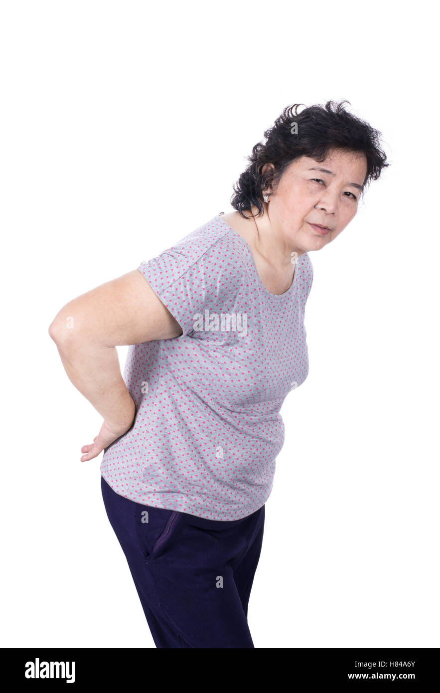 Asian elderly woman with a sick back, backache, isolated on a white ...