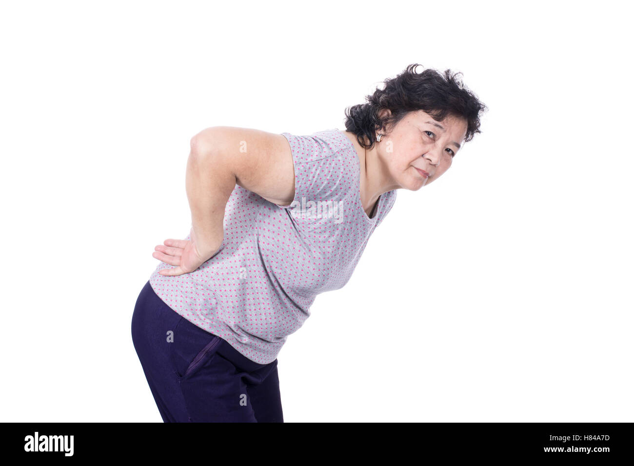 Asian elderly woman with a sick back, backache, isolated on a white ...