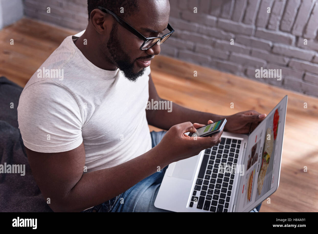 African man using smartphone in bedroom Stock Photo - Alamy