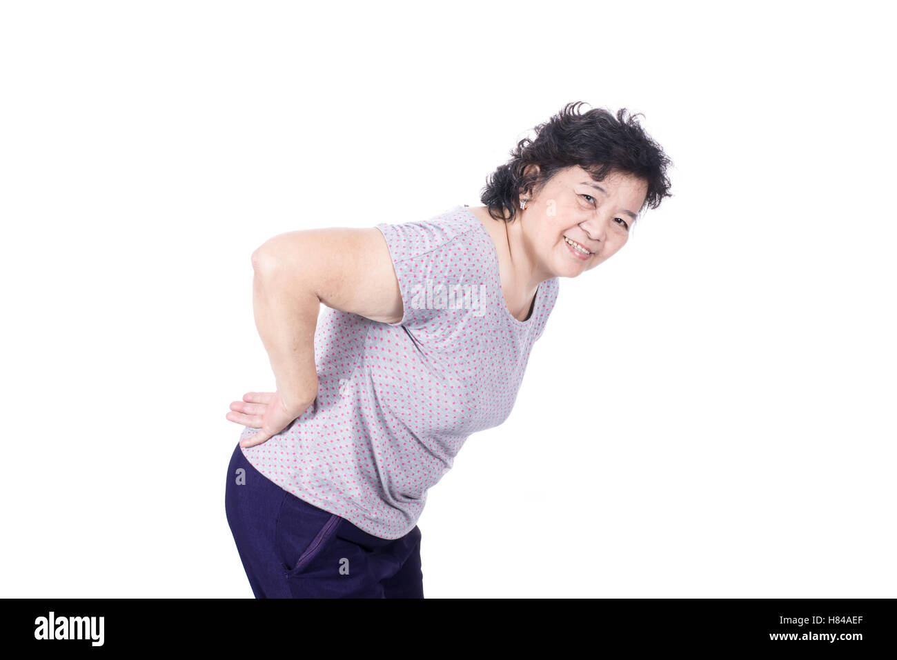 Asian elderly woman with a sick back, backache, isolated on a white ...
