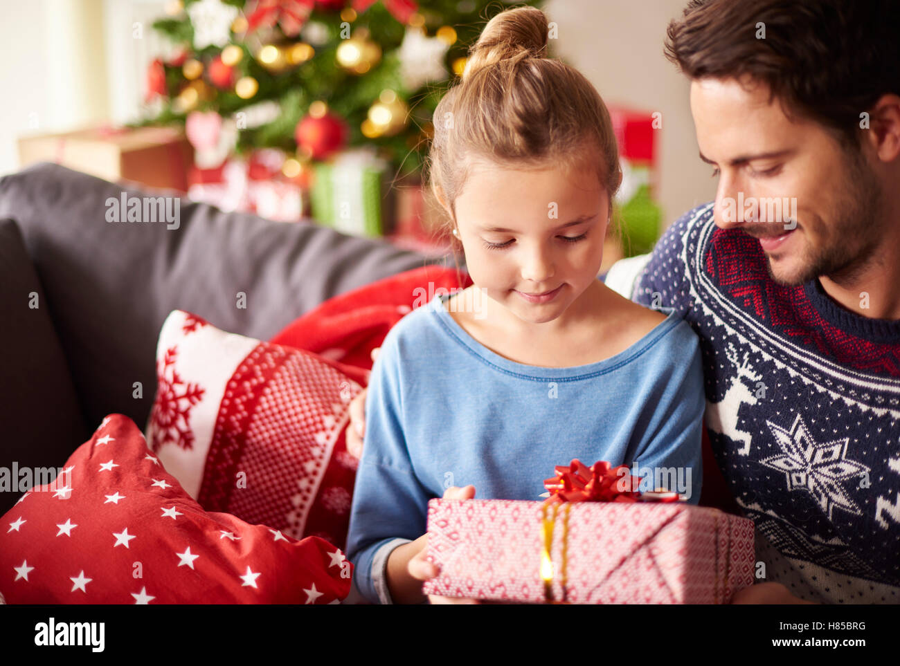 Sharing Christmas presents with daddy Stock Photo - Alamy