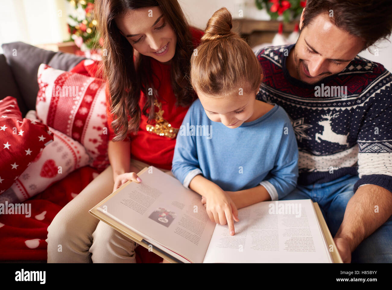Reading interesting stories at Christmas Stock Photo - Alamy