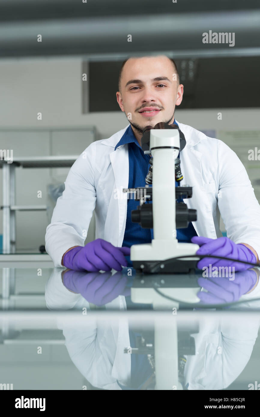 Portrait of caucasian male chemist scientific researcher using ...