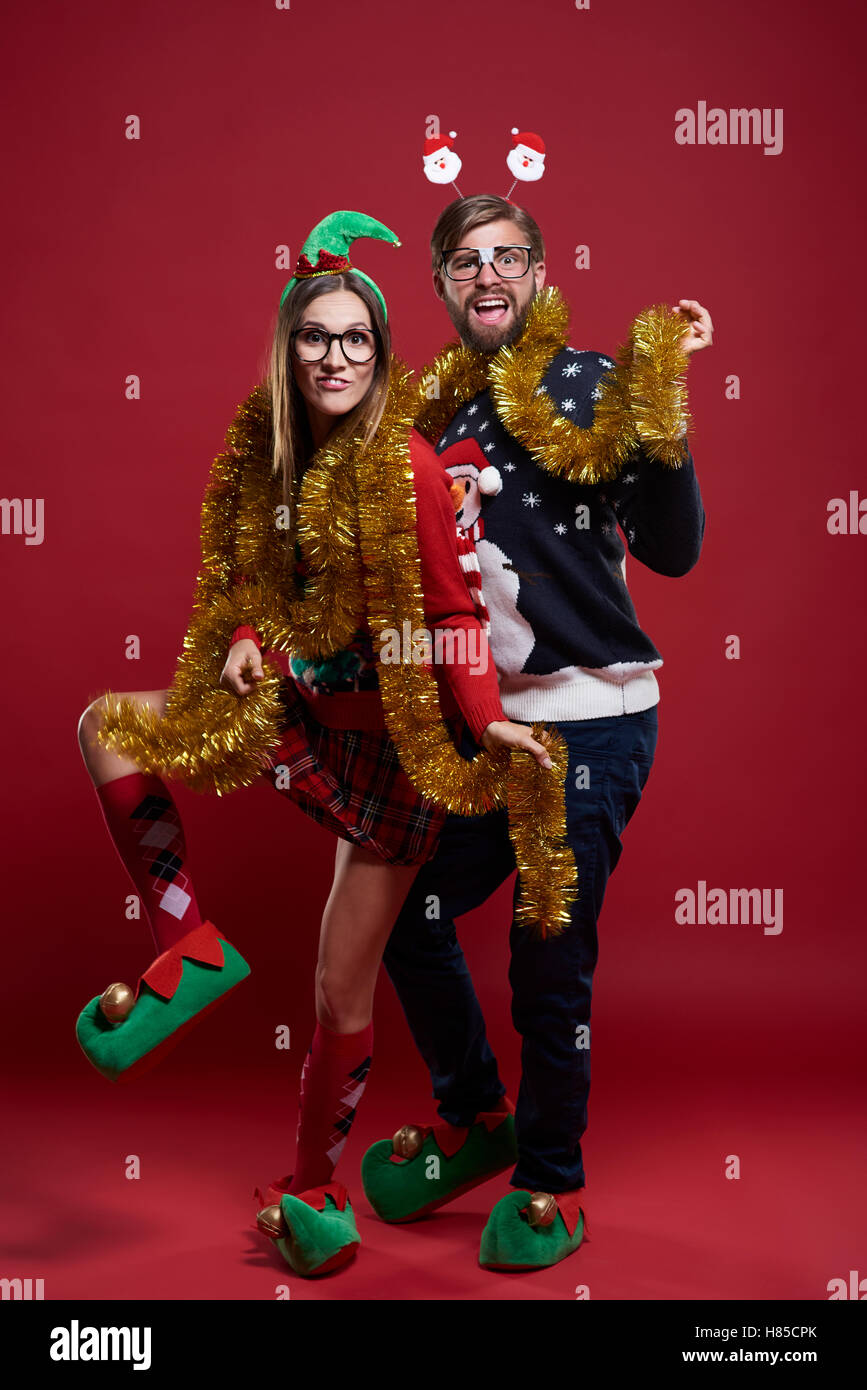 Young couple wearing funny Christmas clothes Stock Photo - Alamy