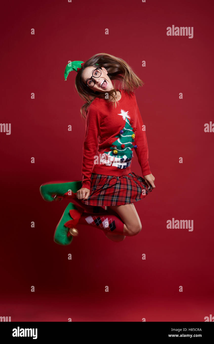 Jumping woman in Christmas clothes Stock Photo - Alamy