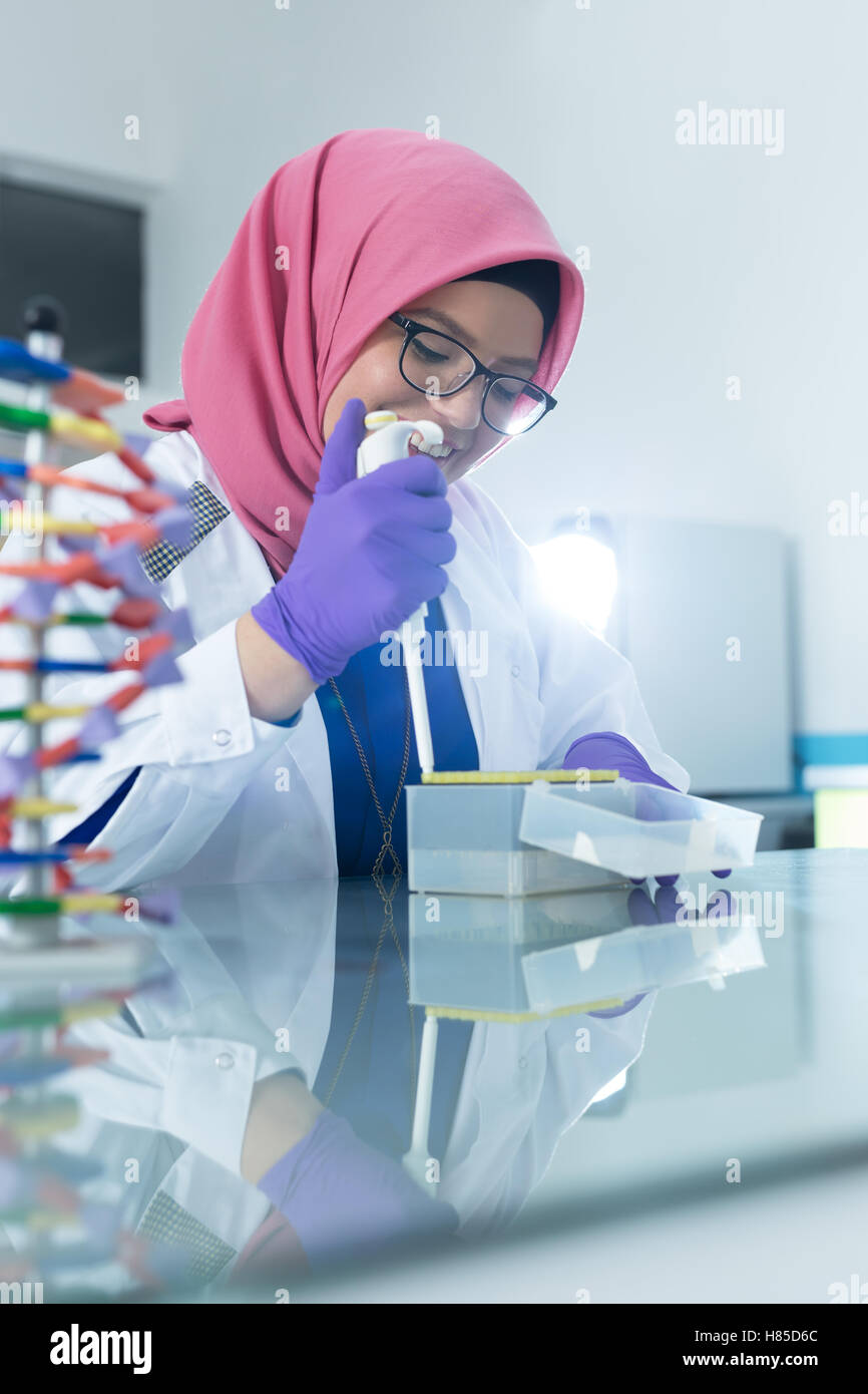 muslim lab worker with hijab or researcher doing an analysis in ...