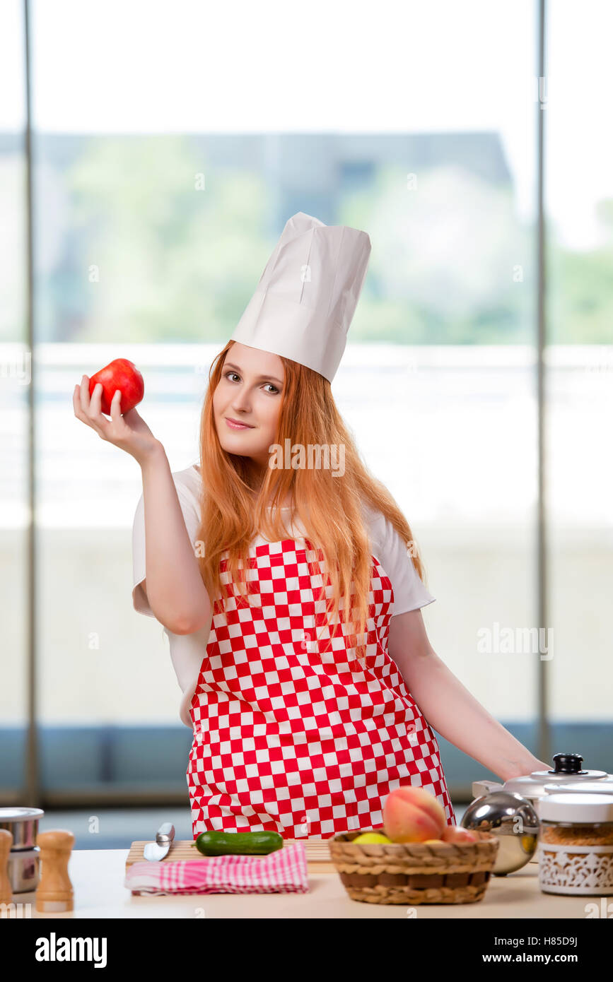 Redhead cook working in the kitchen Stock Photo - Alamy