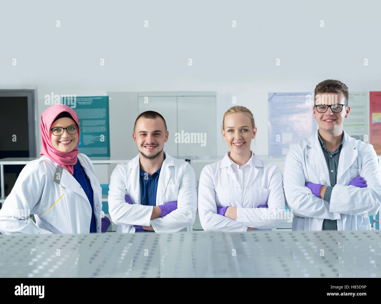 Young scientists in white uniform working in laboratory Stock Photo - Alamy