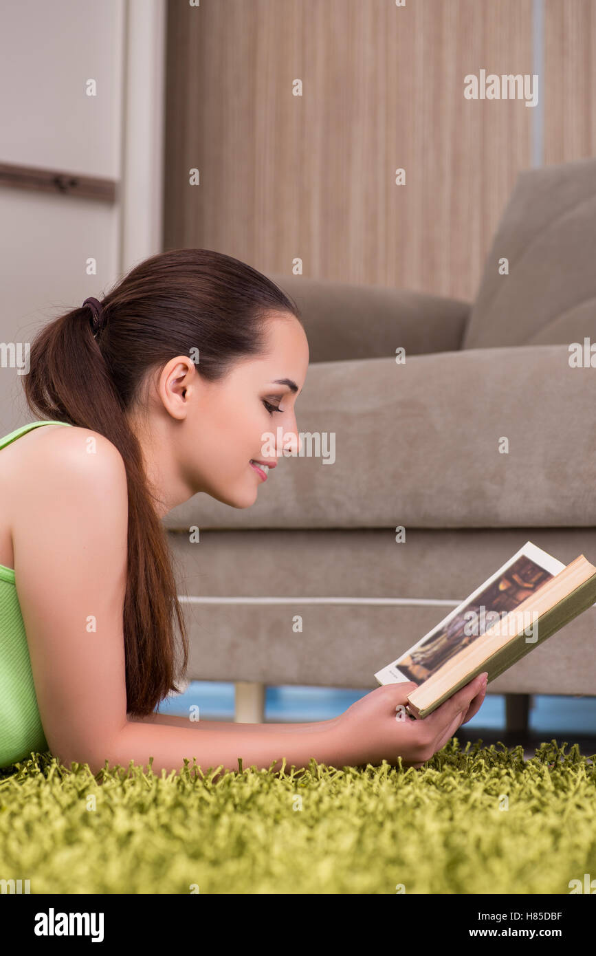 Young woman reading books at home Stock Photo - Alamy