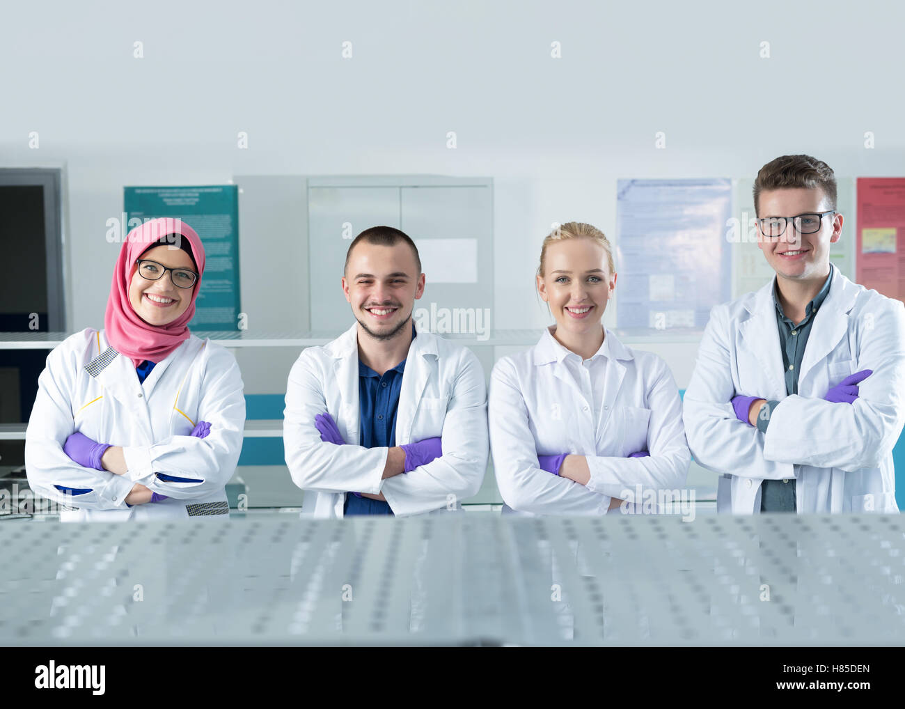 Young scientists in white uniform working in laboratory Stock Photo - Alamy