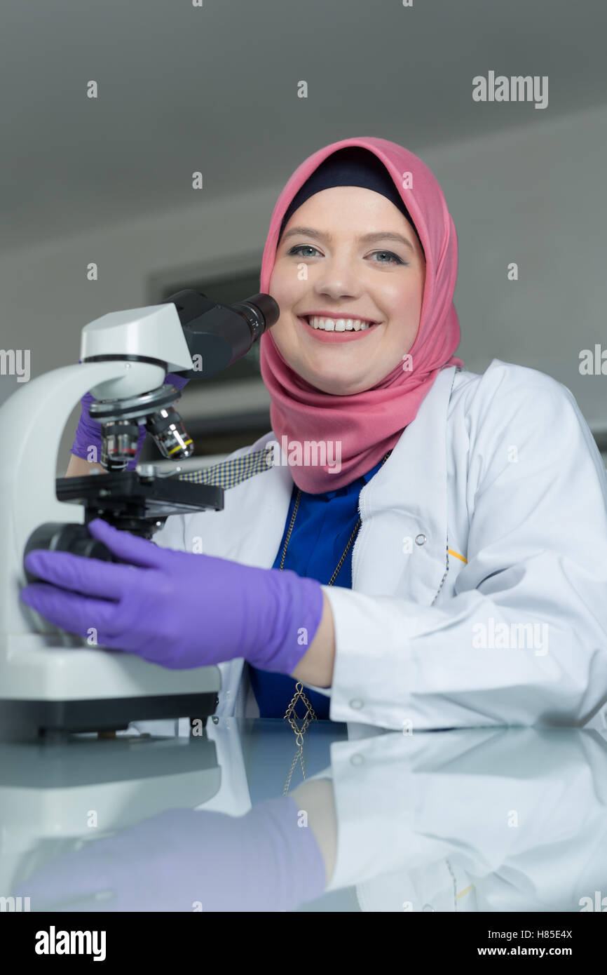 muslim lab worker with hijab or researcher doing an analysis in ...