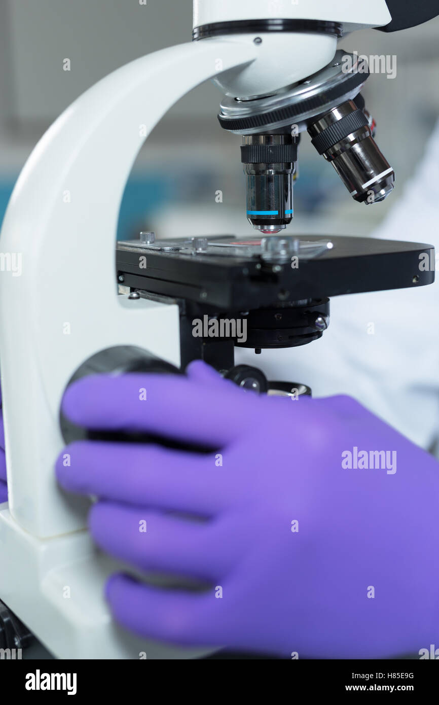 Scientist hands with microscope close-up shot in the laboratory Stock ...