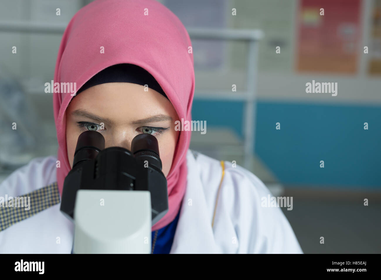 muslim lab worker with hijab or researcher doing an analysis in ...