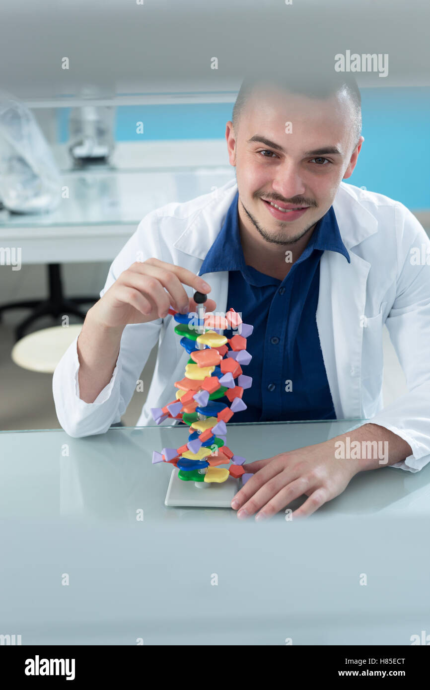 Cheerful young researchers are working in lab Stock Photo - Alamy