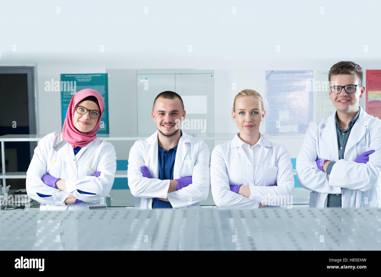 Young scientists in white uniform working in laboratory Stock Photo - Alamy