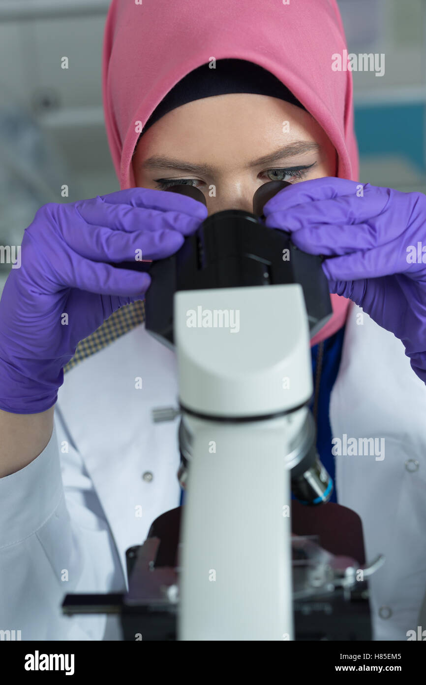 muslim lab worker with hijab or researcher doing an analysis in ...