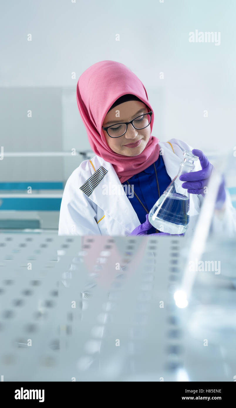 muslim lab worker with hijab or researcher doing an analysis in ...