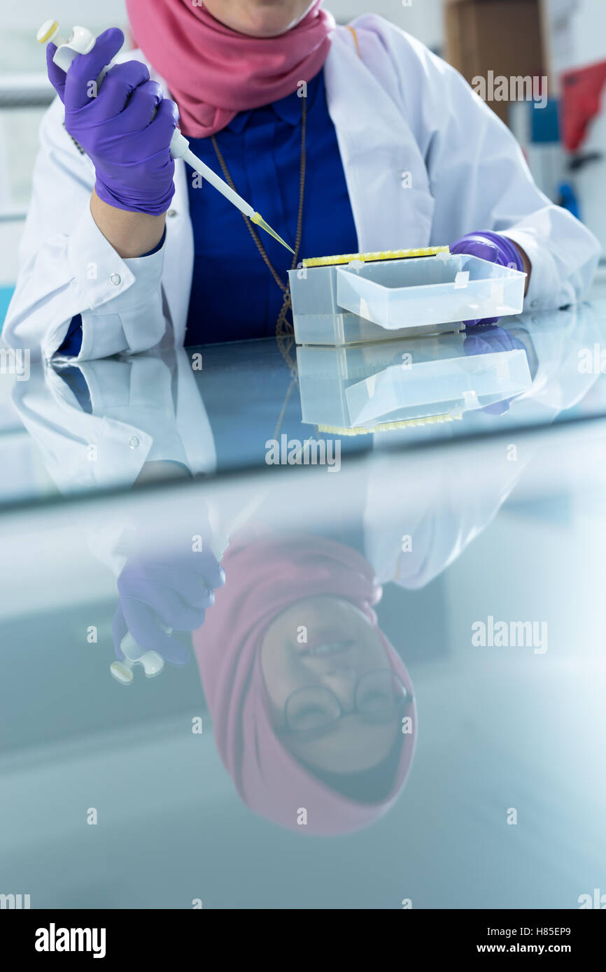 muslim lab worker with hijab or researcher doing an analysis in ...