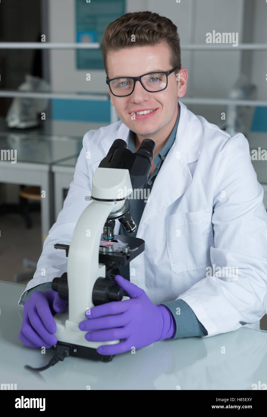 Cheerful young researchers are working in lab Stock Photo - Alamy