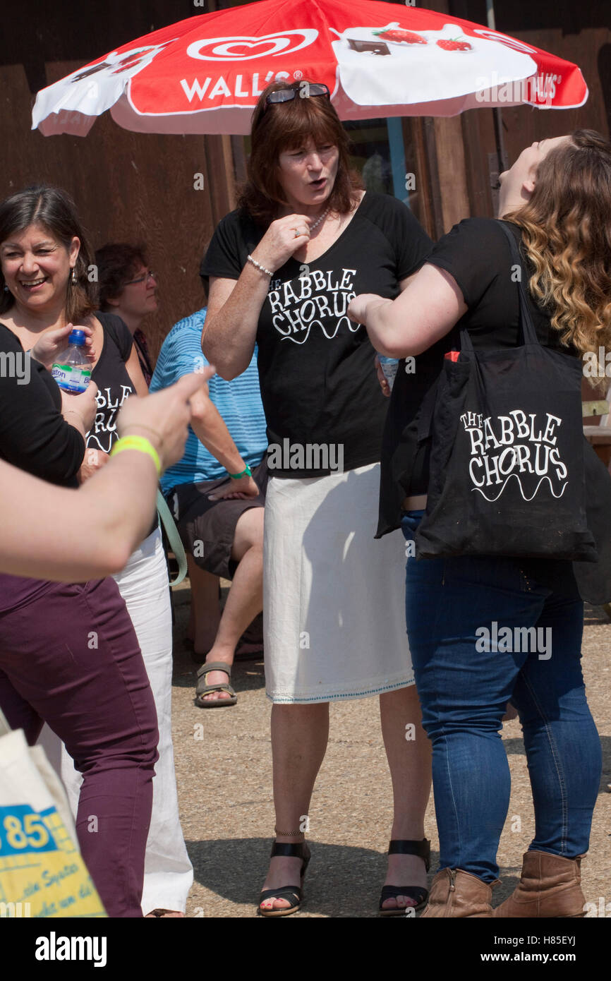 Rabble Chorus choir members laughing Stock Photo - Alamy