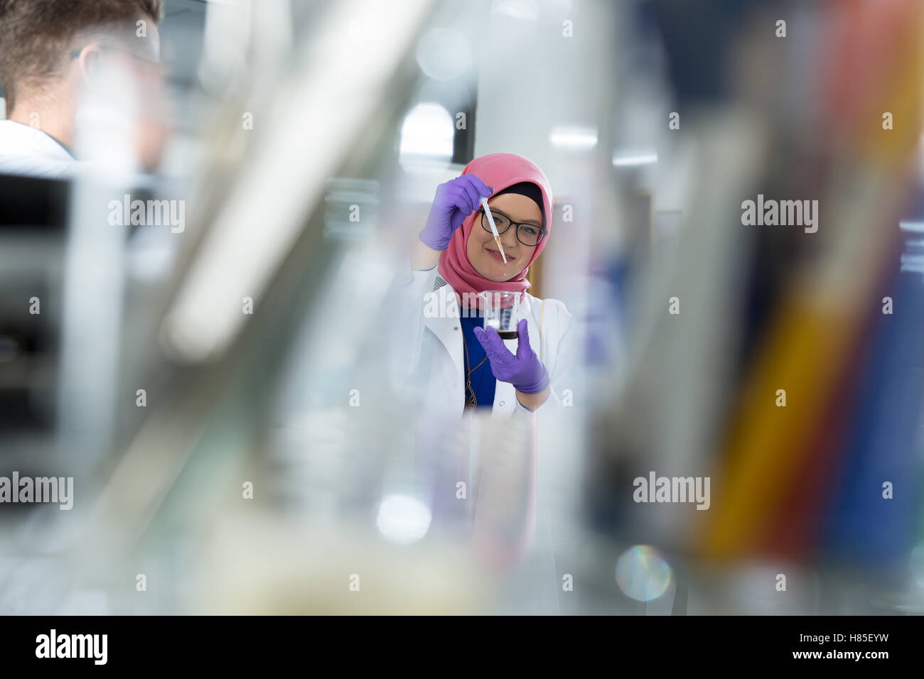 muslim lab worker with hijab or researcher doing an analysis in ...