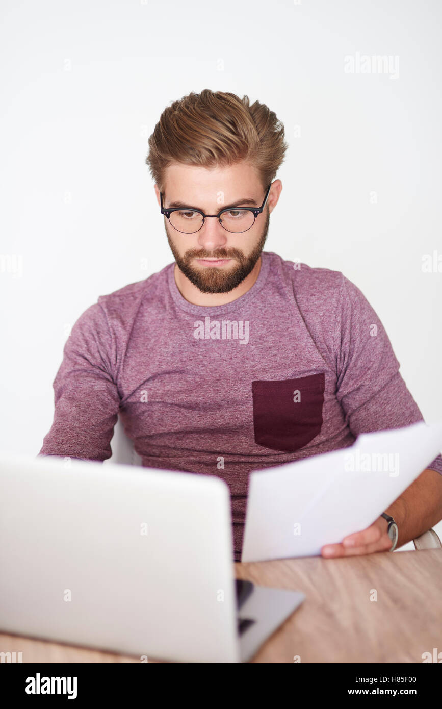 Busy man with laptop and documents Stock Photo - Alamy
