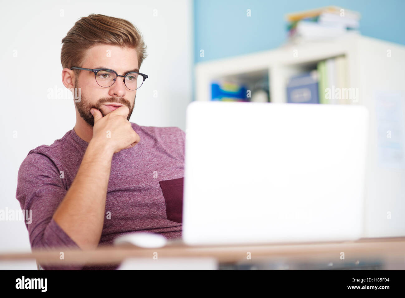 Thoughtful man in front of computer Stock Photo - Alamy