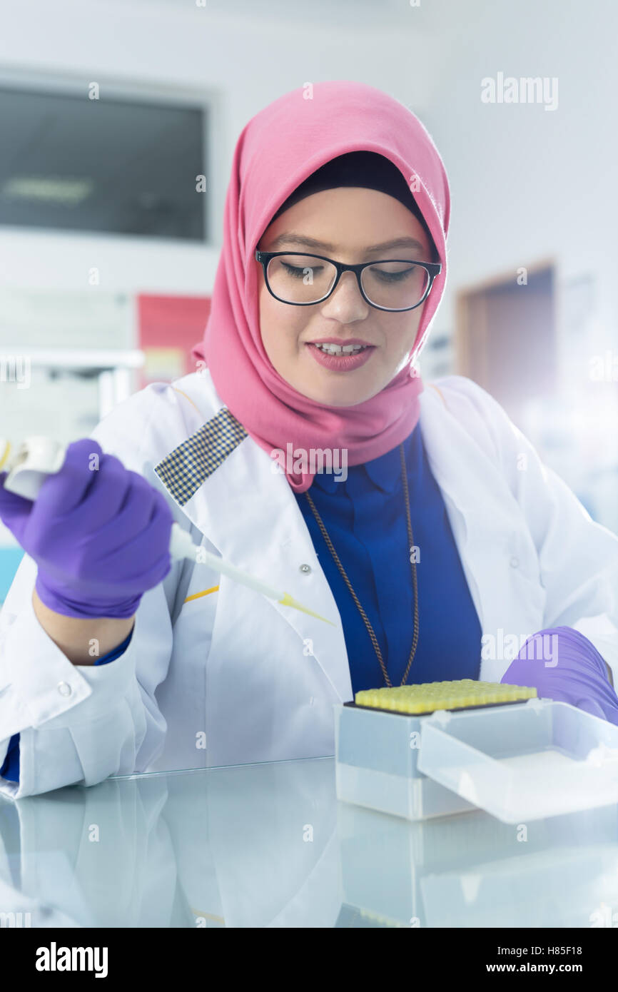 muslim lab worker with hijab or researcher doing an analysis in ...
