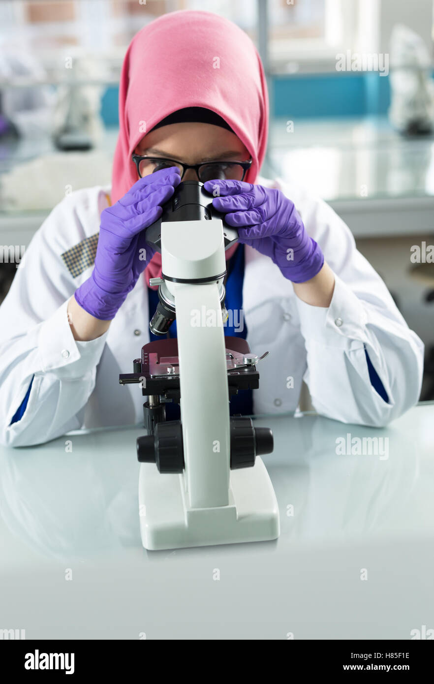 muslim lab worker with hijab or researcher doing an analysis in ...