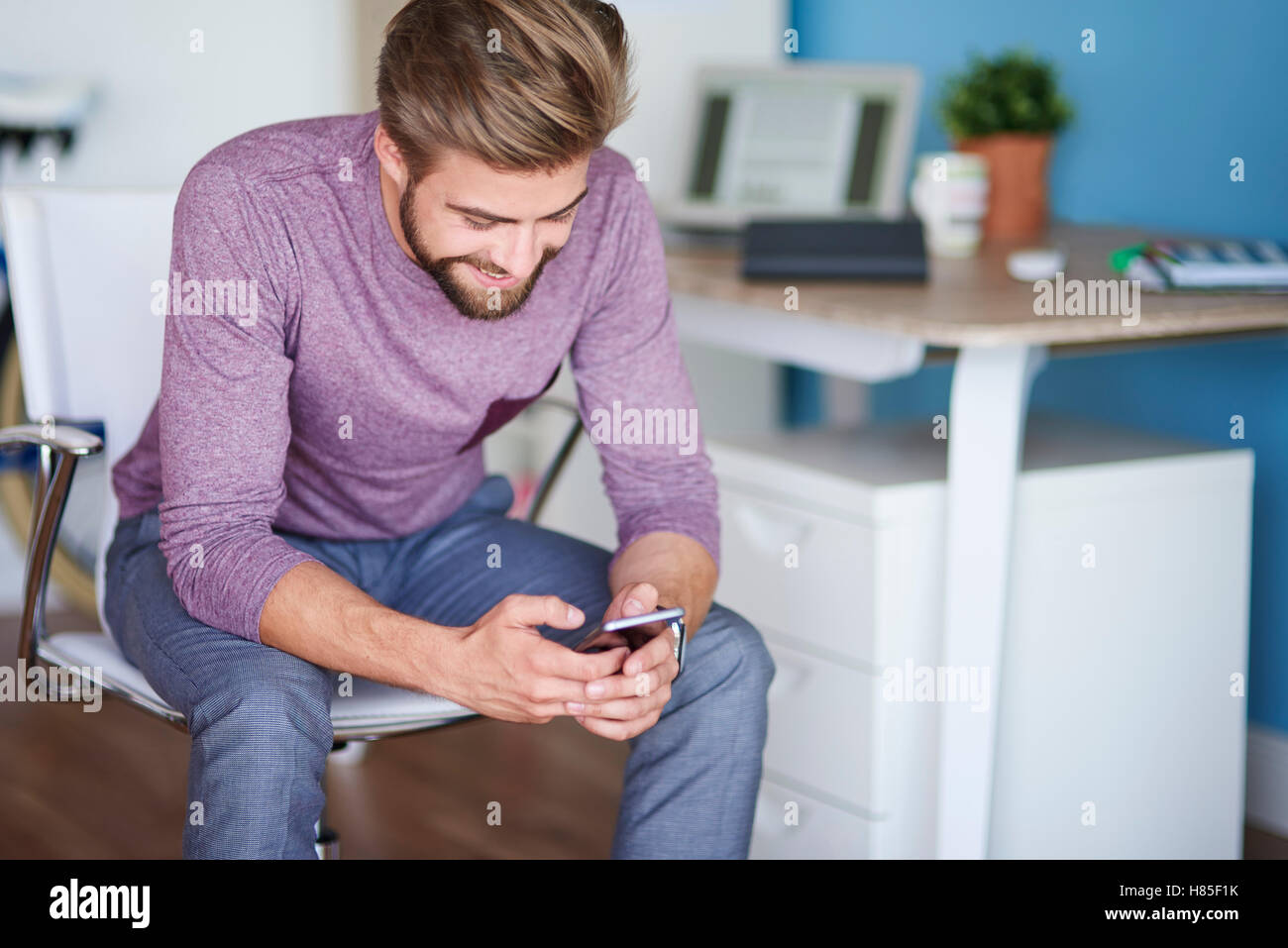 Man looking down on his phone Stock Photo - Alamy