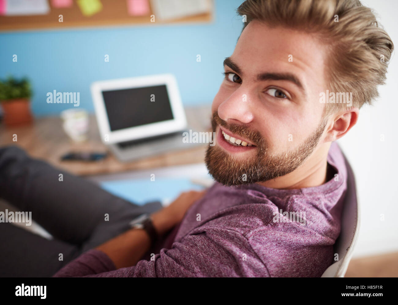 Portrait of a man next to the desk Stock Photo - Alamy