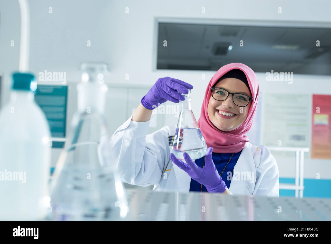muslim lab worker with hijab or researcher doing an analysis in ...