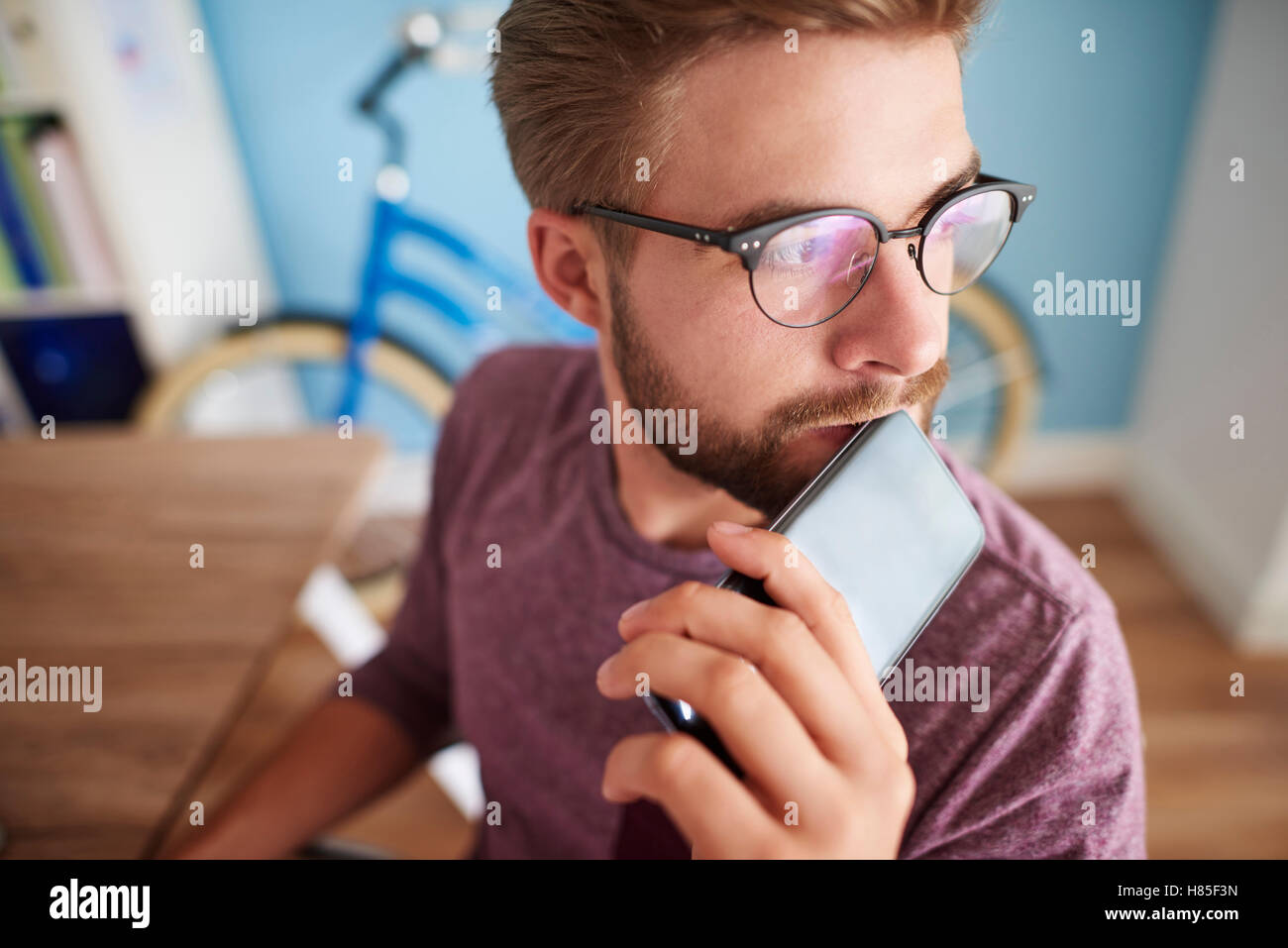 Man with mobilephone looking back Stock Photo - Alamy